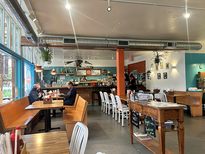 Industrial meets cozy in a space where exposed ductwork and hanging plants create Portland's signature "carefully casual" dining atmosphere.