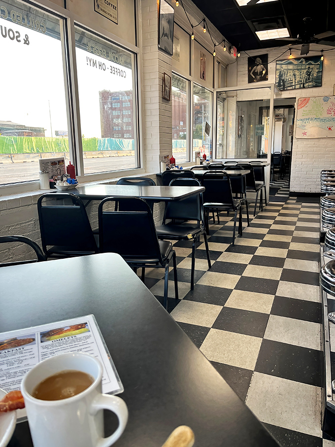 The empty tables won't stay that way for long. Morning light streams through windows, illuminating the checkerboard floor like a chess game waiting to begin.