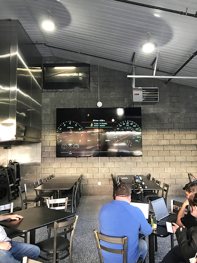 Industrial chic meets beer geek paradise. Those dashboard-inspired screens aren't showing traffic—they're monitoring the brewing process while you dine.