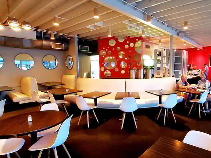 The red accent wall and constellation of circular mirrors create a space that's retro-cool without trying too hard. Austin design at its finest. 