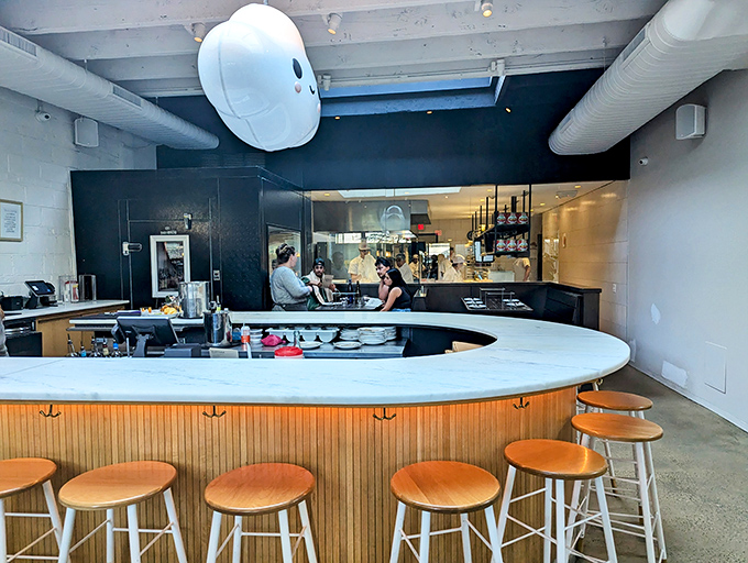 The curved bar invites conversation with strangers who'll soon become friends united by the universal language of exceptional food.