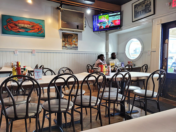 White wainscoting, nautical art, and simple tables create the perfect backdrop for seafood feasting. No distractions from the main event here.