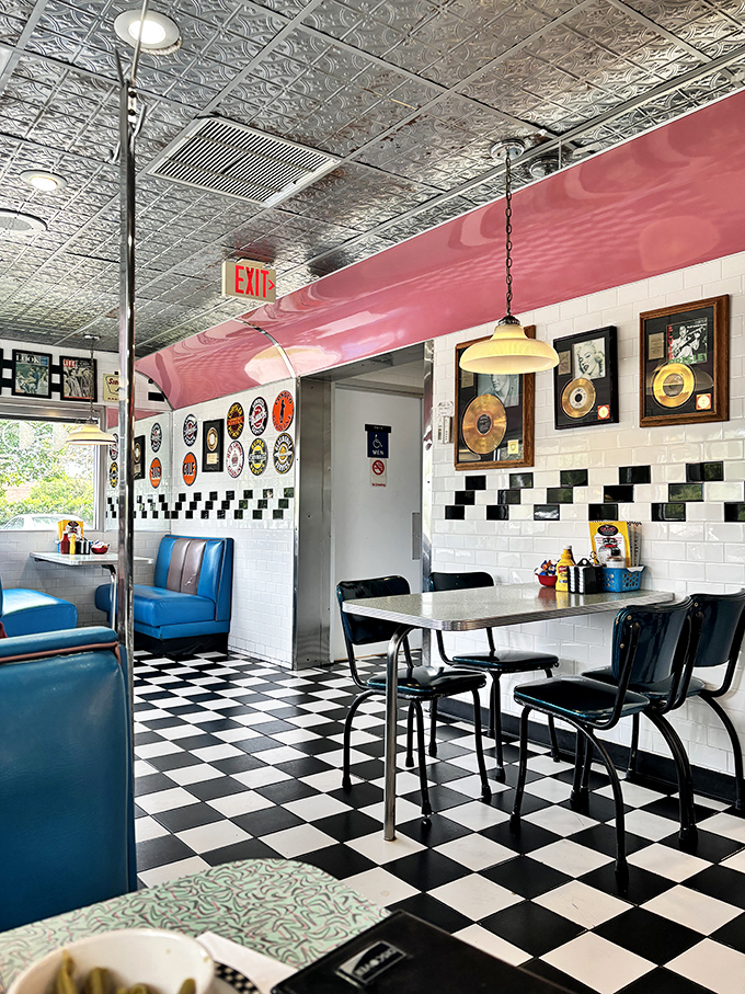 Gold records and vintage pendant lights create the perfect backdrop for life-changing breakfast decisions. The diner's soundtrack is visual and audible.