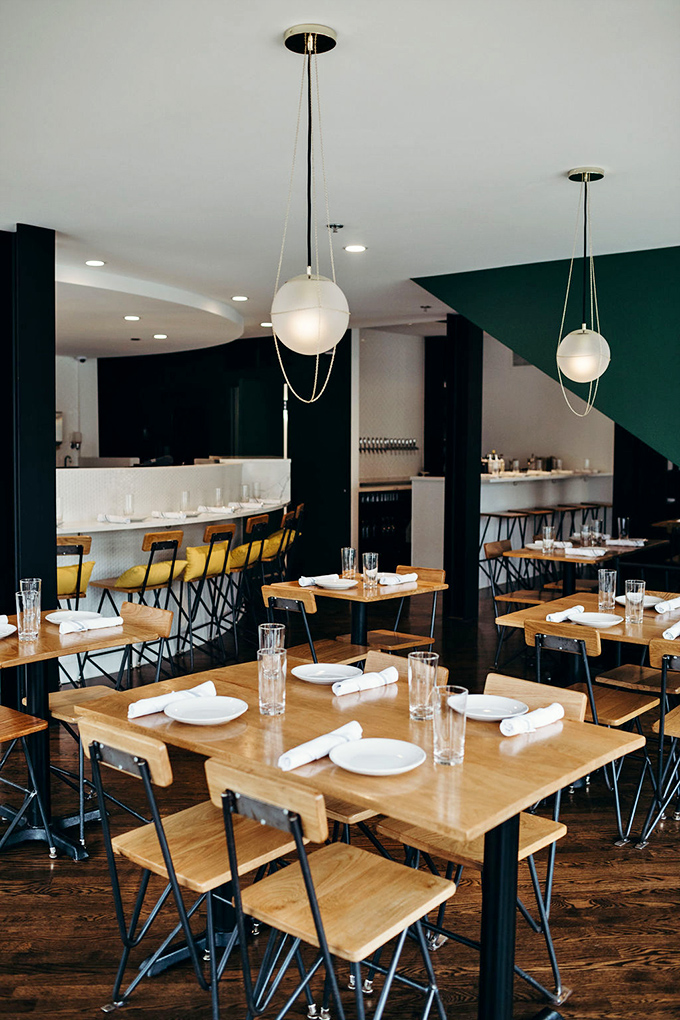 Modern industrial meets warm hospitality in a dining room where every table feels like the best seat in the house.