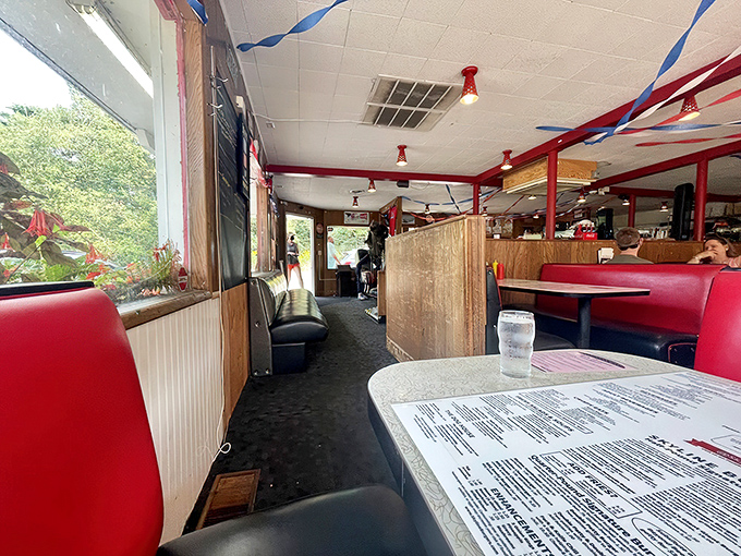 Red vinyl booths and wood paneling create the perfect backdrop for burger bliss, where every table feels like the best seat in the house.