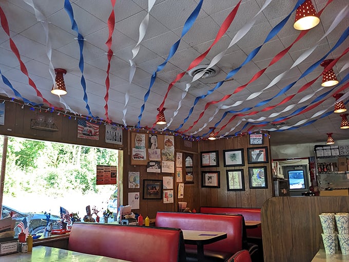 Those red and blue streamers transform an ordinary ceiling into a perpetual celebration of American diner culture. Party above, feast below!