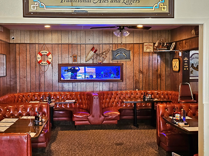Nautical-themed booths create the perfect backdrop for seafood feasts. Those red vinyl seats have supported generations of happy diners.