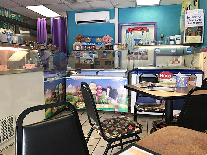 The classic ice cream parlor setup: simple tables, display cases, and the promise that whatever you order will be worth every calorie.