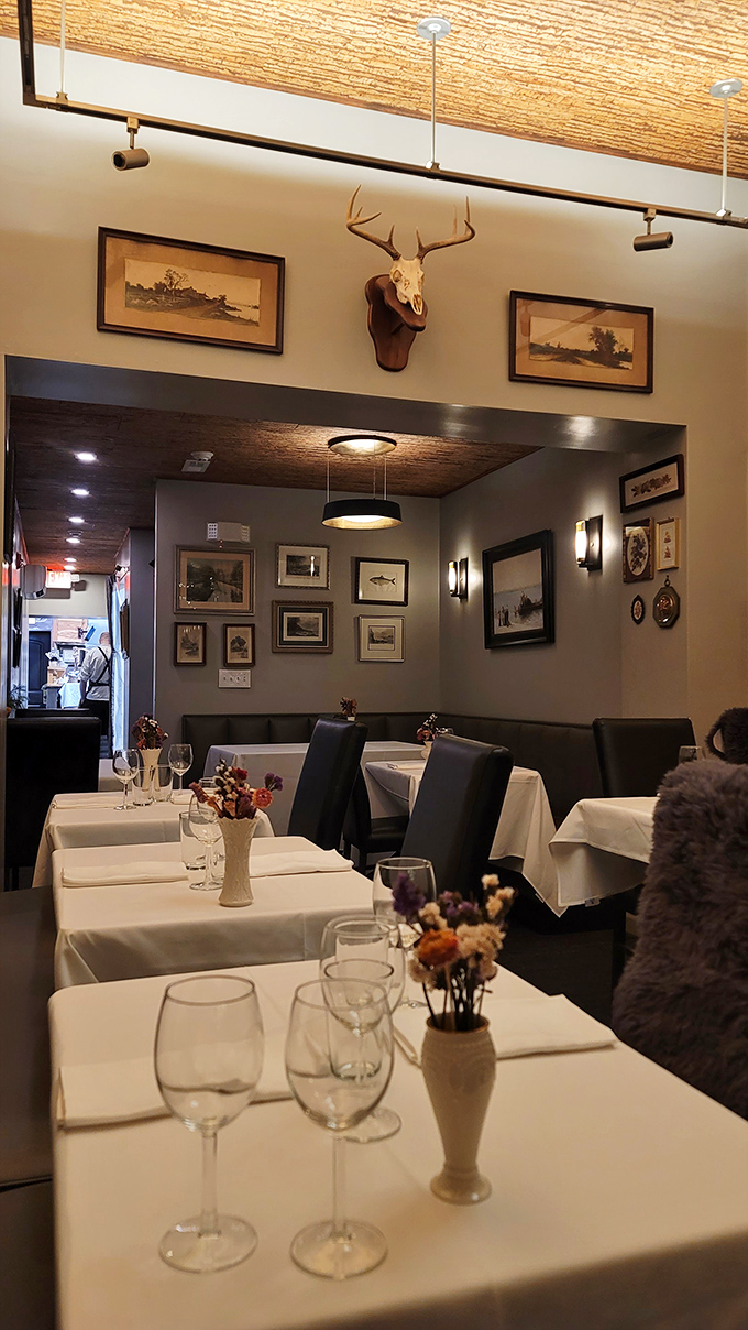 The deer mount watches over diners like a woodland spirit guardian of Pennsylvania cuisine. White tablecloths and rustic touches create the perfect backdrop for memorable meals.