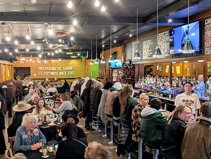 The bustling interior where strangers become friends over shared cheese pulls and craft beer recommendations.