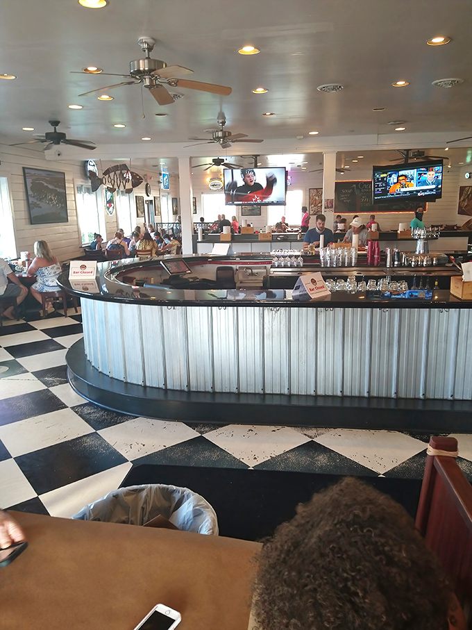 The circular bar serves as the restaurant's social nucleus. Where strangers become friends over oyster shooters and fishing tales.