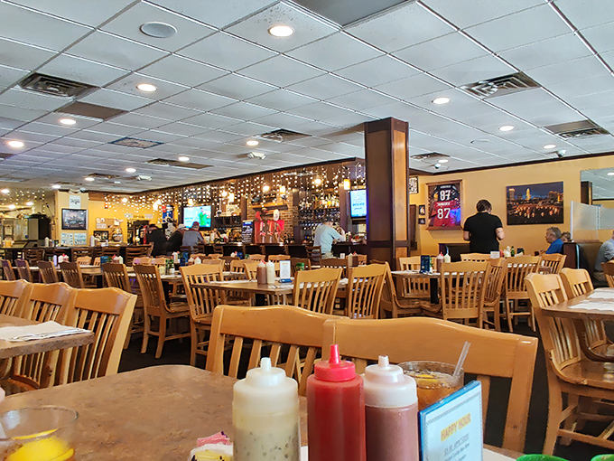 The dining room buzzes with anticipation as wooden chairs cradle seafood seekers. Notice the condiment bottles&mdash;essential tools for the journey ahead.