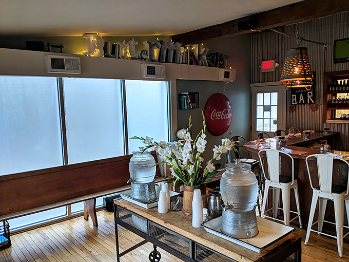 Rustic charm meets modern comfort in a dining room where weathered wooden beams frame conversations and the clinking of forks against plates.
