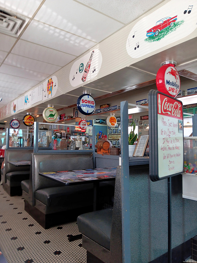 Booths upholstered in that unmistakable diner vinyl create intimate islands in a sea of nostalgia, while vintage signs promise authenticity you can taste.