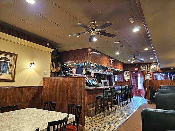 The bar area where locals gather to debate everything from politics to pizza toppings. Those wood panels have absorbed decades of laughter, stories, and the occasional heated sports argument.