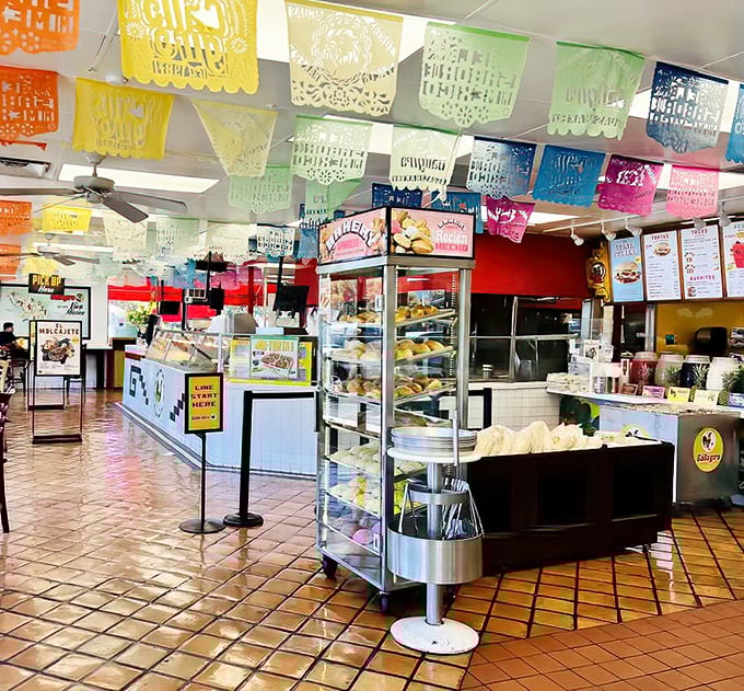 The papel picado ceiling and well-stocked bakery cases aren't just decoration &ndash; they're a promise that what you're about to eat comes from generations of tradition.