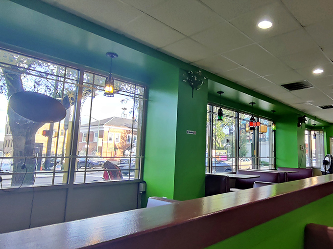 Booth seating bathed in natural light and surrounded by those signature green walls. The view outside is nice, but the plates coming from the kitchen are the real scenery.
