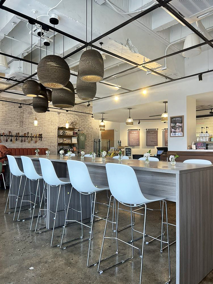 The counter seating offers front-row tickets to the culinary show, with those sculptural pendant lights stealing scenes from above.