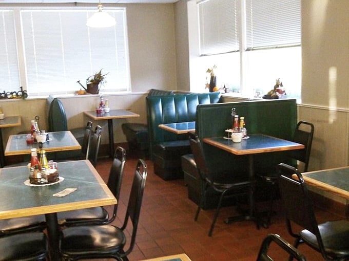 Another dining area showcases teal booths against cream walls&mdash;unpretentious and ready for the serious business of enjoying good food.