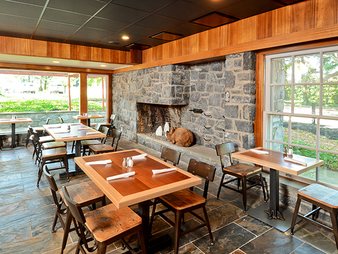 Stone walls and wooden tables create a rustic sanctuary where the only appropriate religion is the worship of properly smoked meat.
