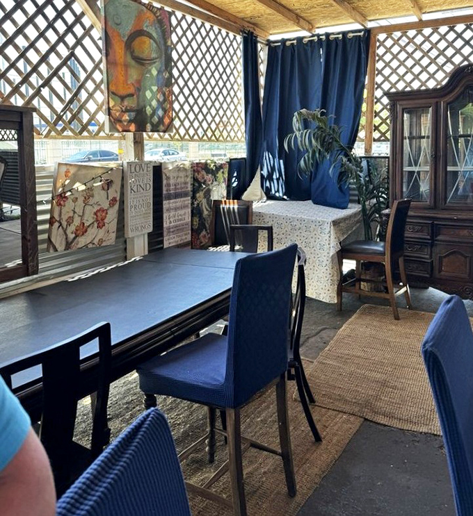 Another angle of the patio reveals more thoughtful touches—blue curtains, natural light filtering through lattice, and enough plants to make you feel like you're dining in a secret garden.
