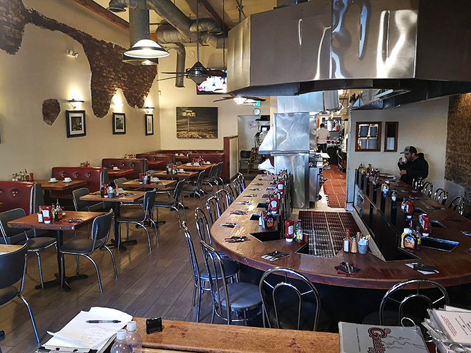 The counter seating offers front-row tickets to the breakfast theater, where pancake flipping becomes performance art.