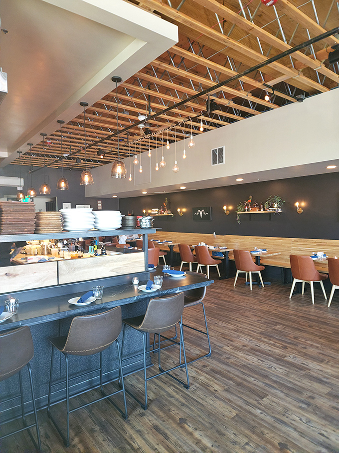 Exposed wooden beams, pendant lighting, and thoughtful design create an atmosphere where comfort meets sophistication. Dinner and a show&mdash;architectural edition.