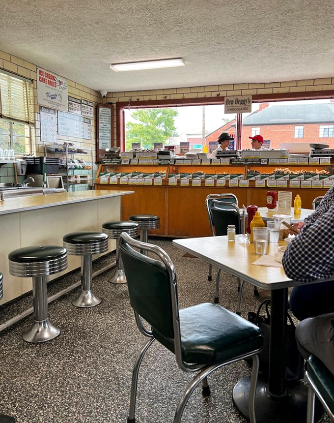 Classic counter seating where ice cream dreams come true. Those stools have supported generations of dessert enthusiasts mid-revelation.