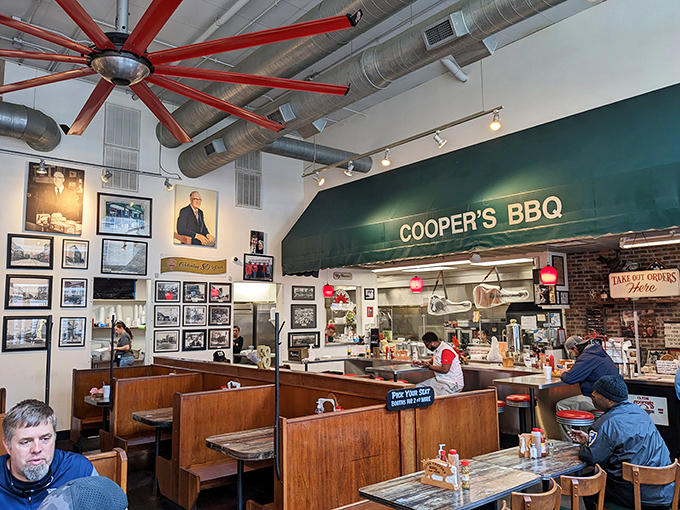 The green awning marks the border between ordinary life and barbecue bliss. Those ceiling fans have been pushing the aroma of smoked pork through Raleigh for decades.