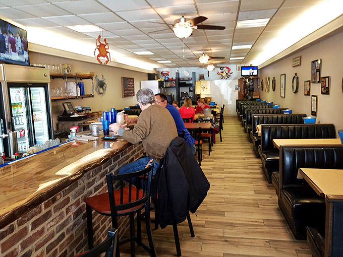 The bar area offers refuge for solo diners and regulars who know that sometimes the best conversations happen over cracking shells.