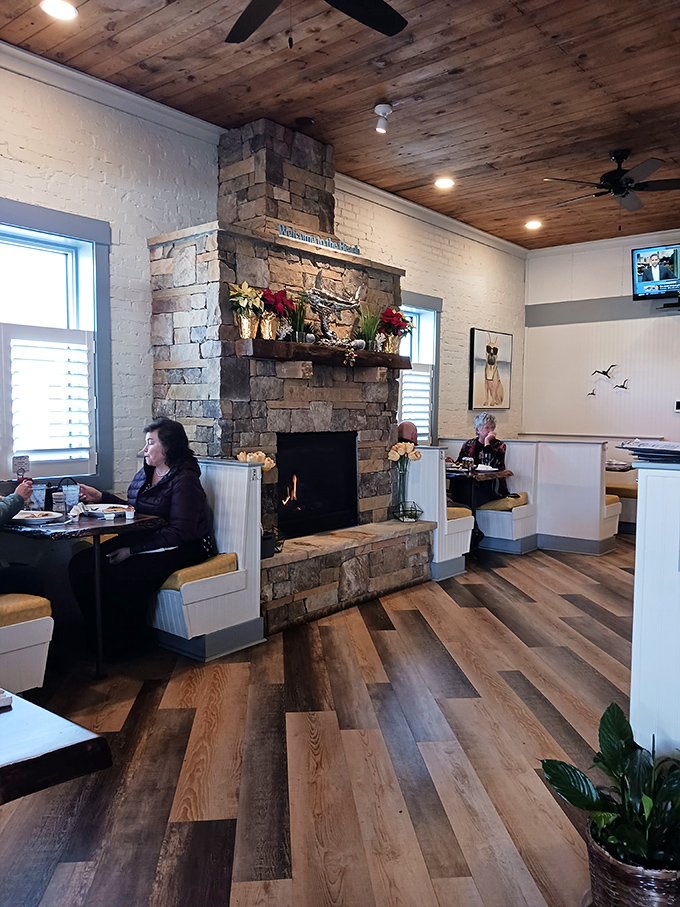 That stone fireplace isn't just for show—it's the heart of this dining room, warming both the space and your breakfast-loving soul.