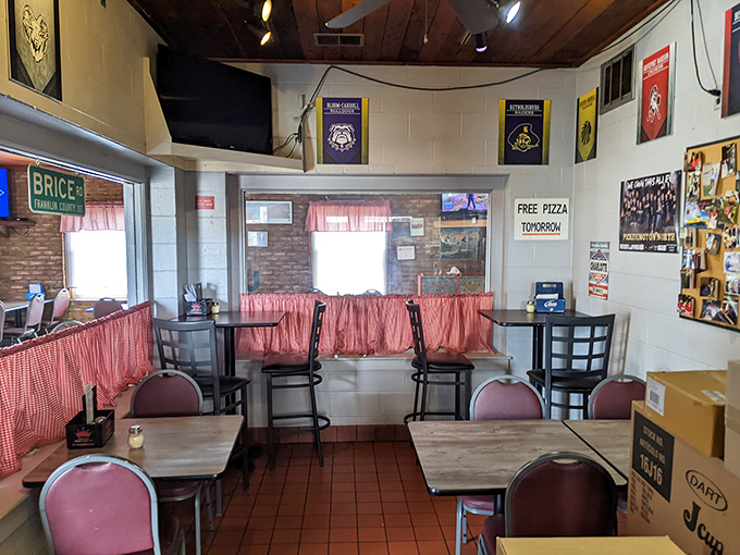 The dining room feels like it was designed by someone who values conversation and comfort over trendy aesthetics. Those pink curtains make another charming appearance.