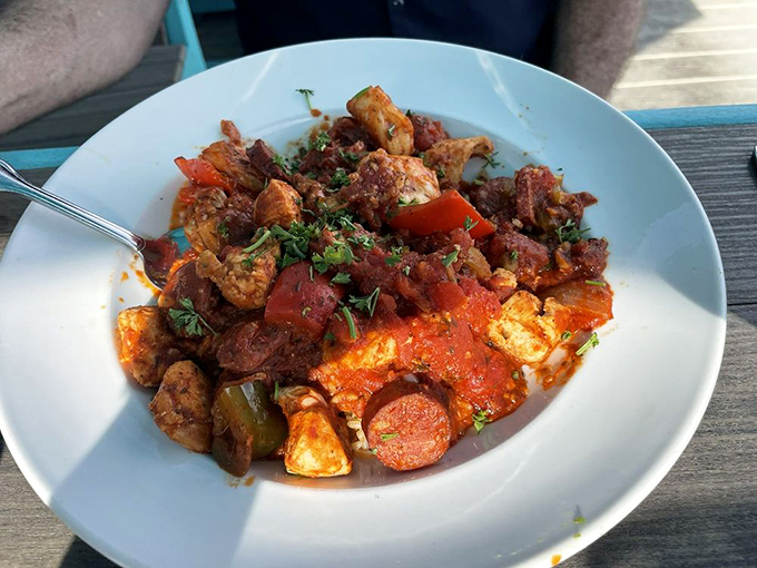 This jambalaya looks like a party where sausage, seafood, and spice all showed up wearing their Sunday best. The kind of dish that demands a nap afterward.