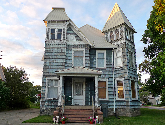 This weathered Victorian beauty has seen better days but retains its architectural dignity, a faded postcard from another era.