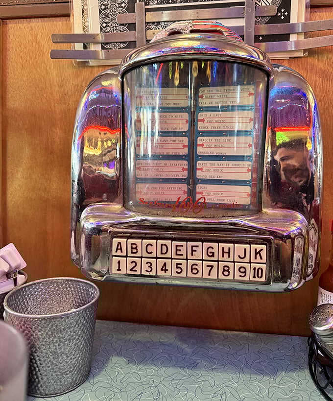 The vintage tabletop jukebox waits for your quarters and musical whims—a chrome-plated time capsule of American pop culture.