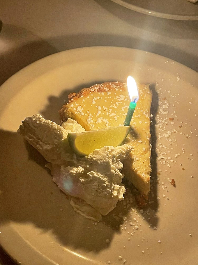 Key lime pie that hits all the right notes—tangy, sweet, with a candle that says "yes, this is absolutely worth celebrating."