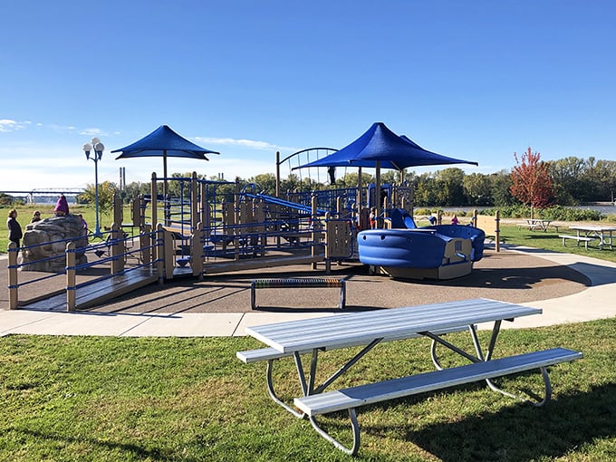 Lincoln Park's playground offers Mississippi River views that make pushing a swing feel like a luxury vacation activity for budget-conscious parents.