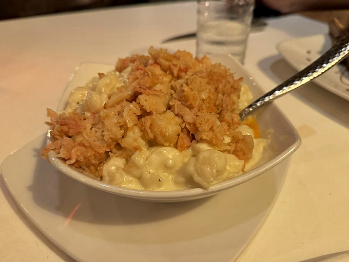 Lobster mac and cheese that's having an identity crisis in the best possible way&mdash;comfort food dressed in black tie, topped with crispy onions for textural jazz hands.