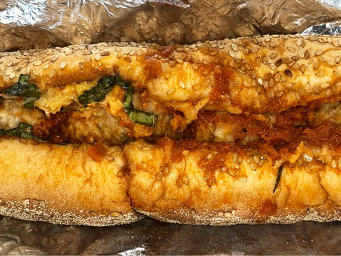 A proper cheesesteak in its natural habitat&mdash;wrapped in foil, ready to be devoured alongside crispy fries and an ice-cold soda.