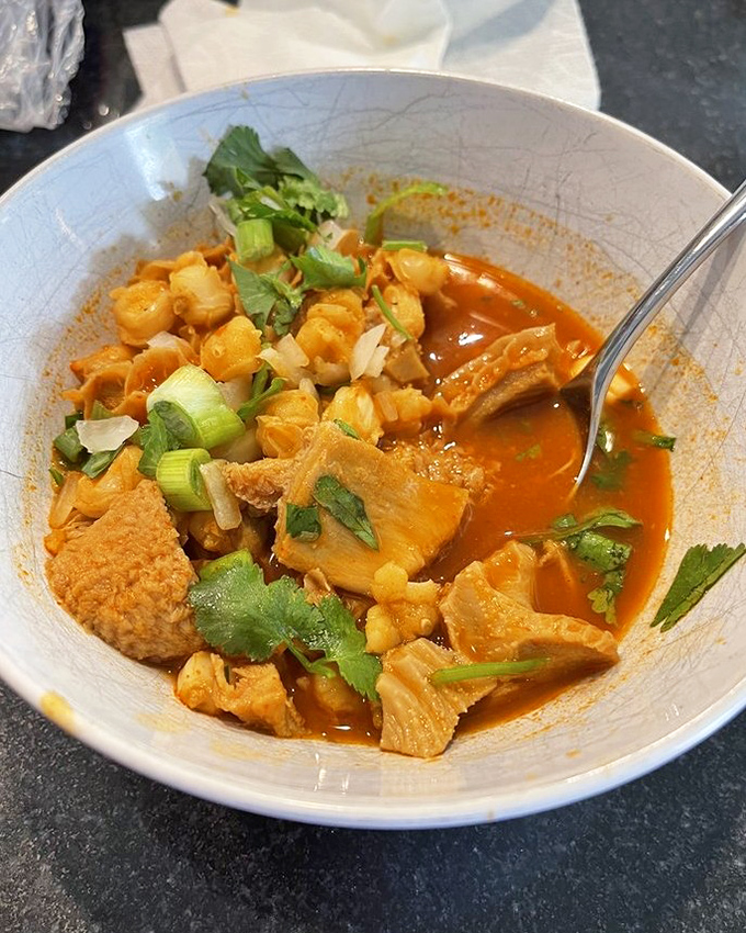 This menudo isn't just soup—it's a spicy, aromatic potion served in a volcanic stone vessel that could cure anything from hangovers to existential dread.