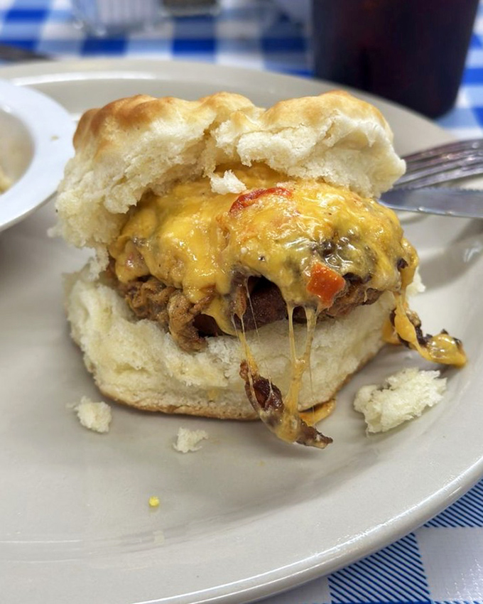 This biscuit sandwich isn't just breakfast, it's an architectural marvel of melty cheese, meat, and fluffy bread engineering.