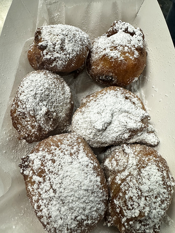 Powdered sugar snowcaps on golden-fried dough mountains. These sweet treats are what donut holes dream of becoming when they grow up.