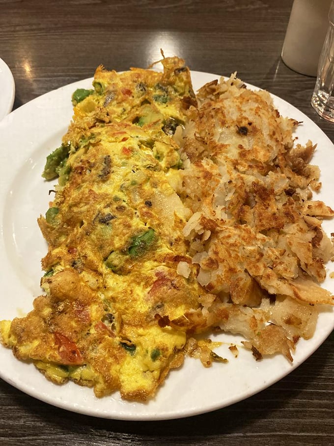 An omelet that's clearly been to culinary finishing school&mdash;perfectly folded, generously filled, and paired with hash browns crisped to golden perfection.