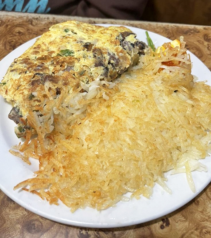 An omelet so perfectly executed it deserves its own Food Network special, with hash browns crisped to the exact point between heaven and earth.