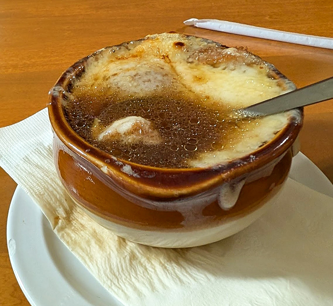 French onion soup so authentic it makes you want to don a beret and argue about existentialism between delicious, cheese-pulling spoonfuls.