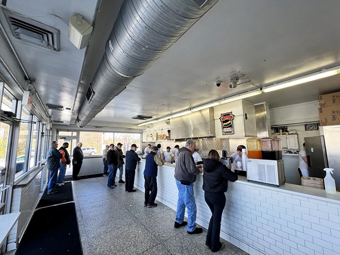 The assembly line of flavor operates with military precision. No wasted movements, no unnecessary flourishes&mdash;just hot dog perfection.