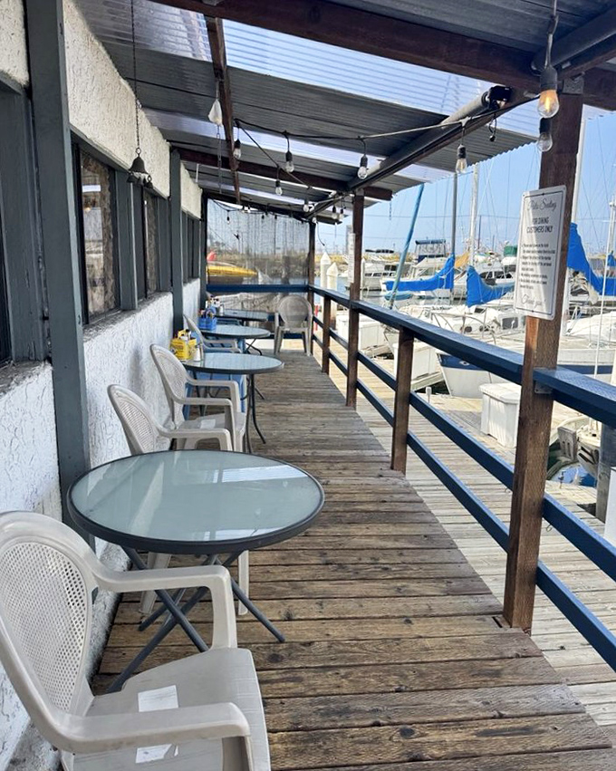 Outdoor seating where every table comes with a million-dollar marina view. The weathered deck boards tell stories of countless satisfied diners.