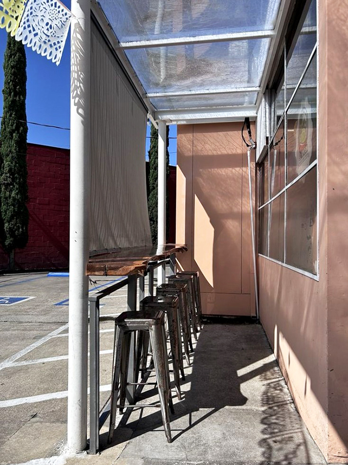 The outdoor counter seating offers prime people-watching real estate with the added bonus of being first in line when fresh batches arrive.