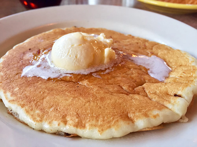 A pancake so fluffy it could float away if not anchored by that perfect pat of butter slowly melting into a maple syrup lagoon.
