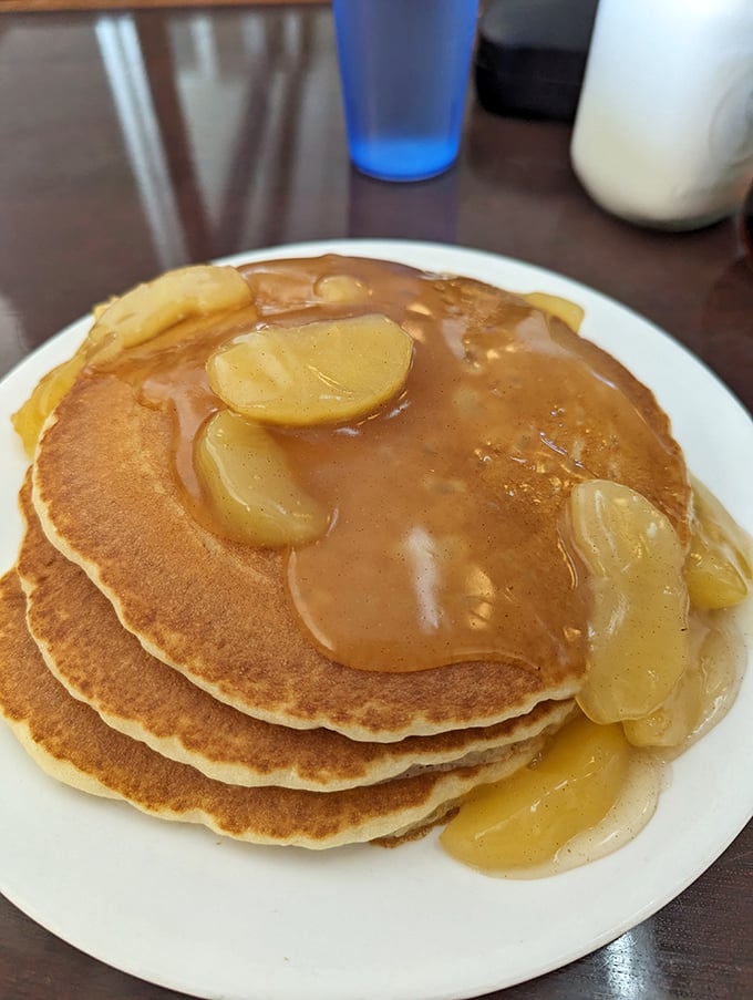 Apple pancakes glistening with syrup and fruit&mdash;proof that sometimes the simplest pleasures are the most profound.